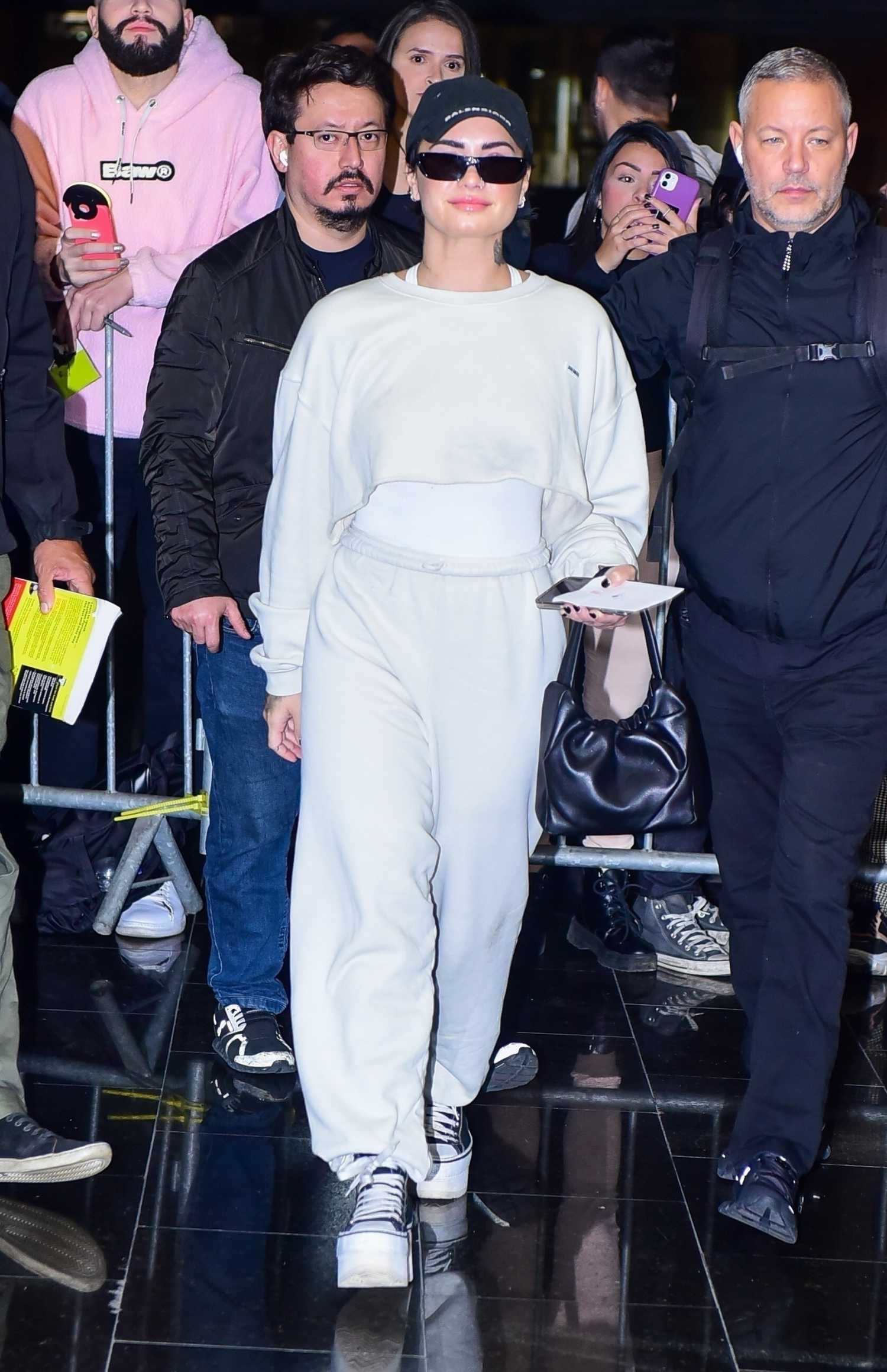 Demi Lovato in a Black Cap Arrives at the Galeao Airport in Rio de ...
