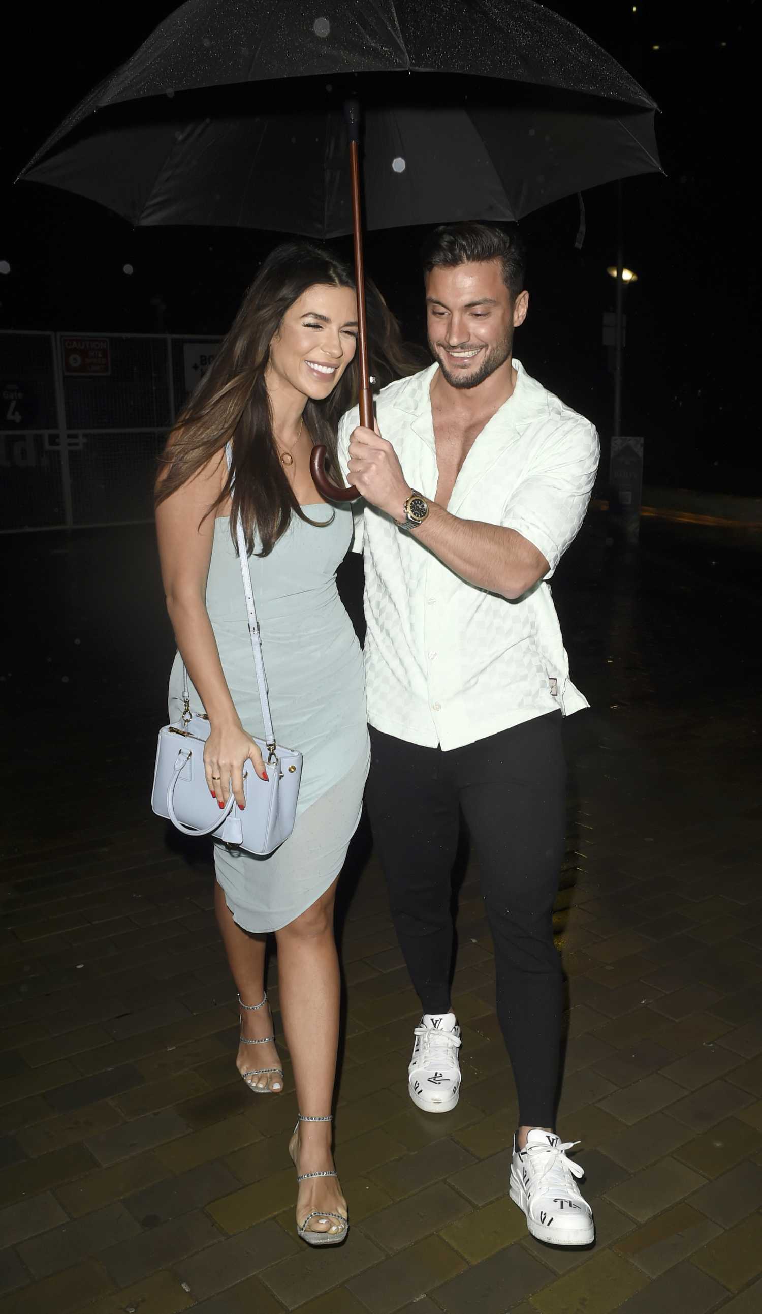 Ekin-Su Cülcüloğlu in a Baby Blue Dress in the Rain on New Year Date ...