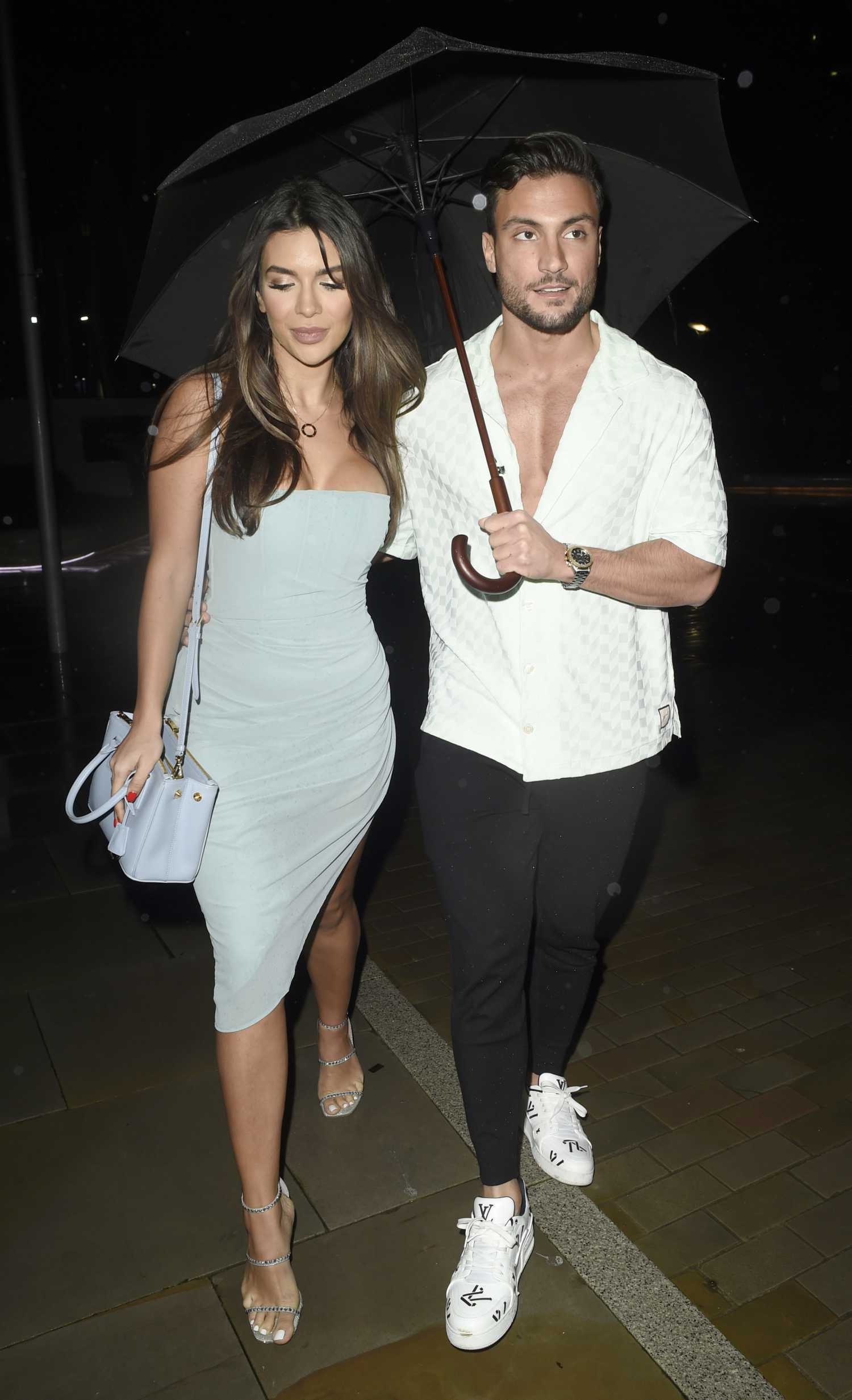 Ekin-Su Cülcüloğlu in a Baby Blue Dress in the Rain on New Year Date ...