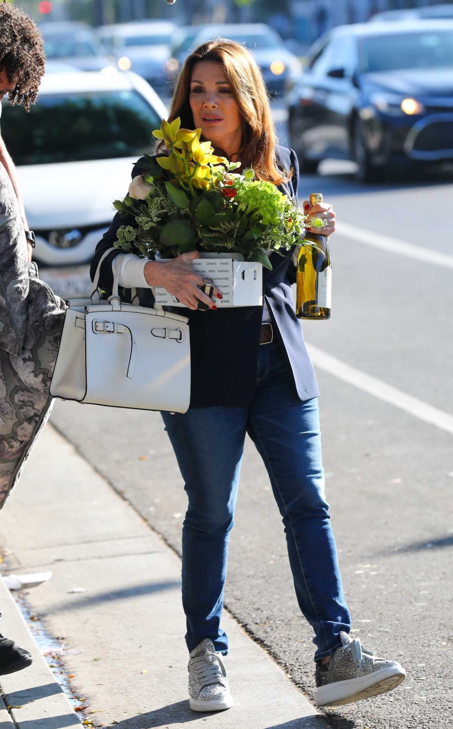Lisa Vanderpump in a Silver Sneakers Carries Flowers Gifted by Tom ...